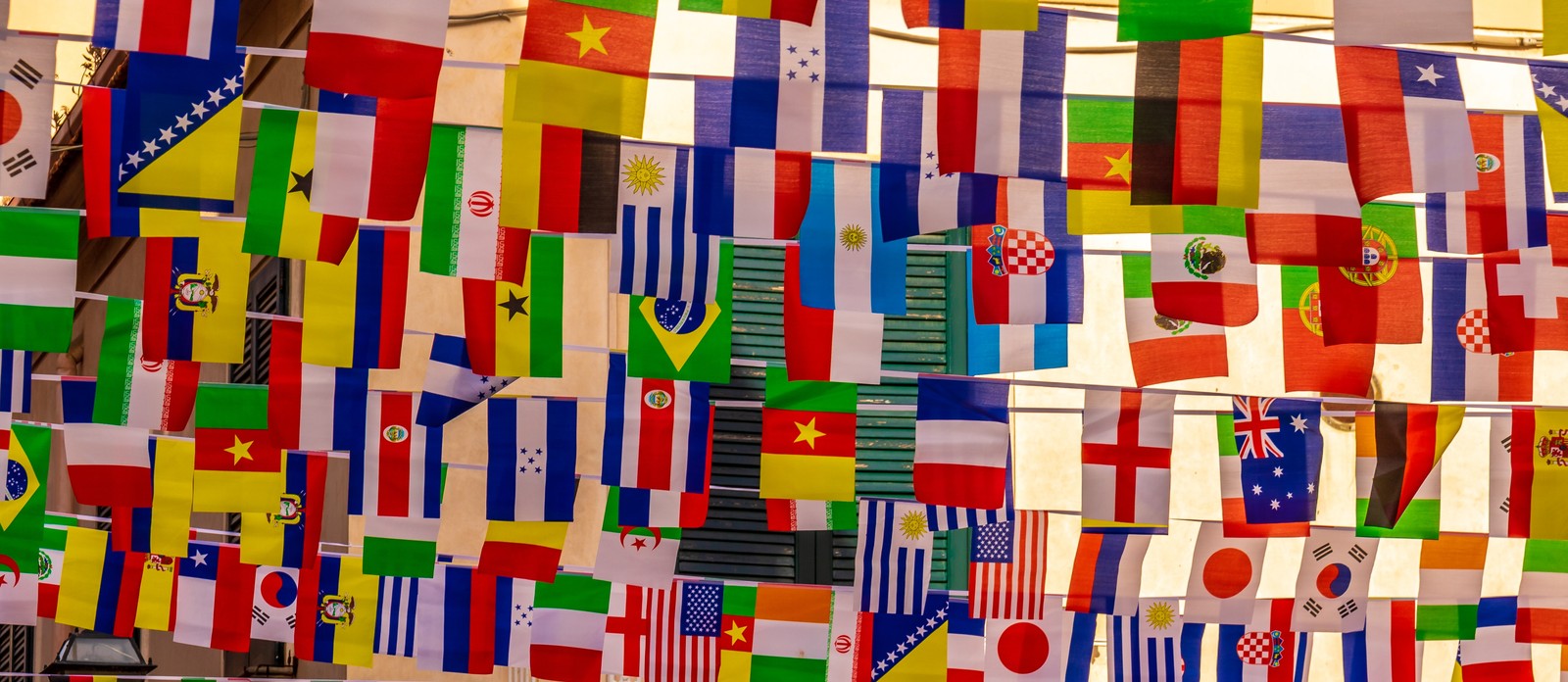 What Island's flag is composed of three armored legs?